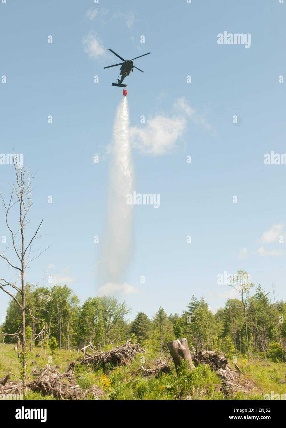 Water is released from a bambi bucket over a simulated fire from one of ...