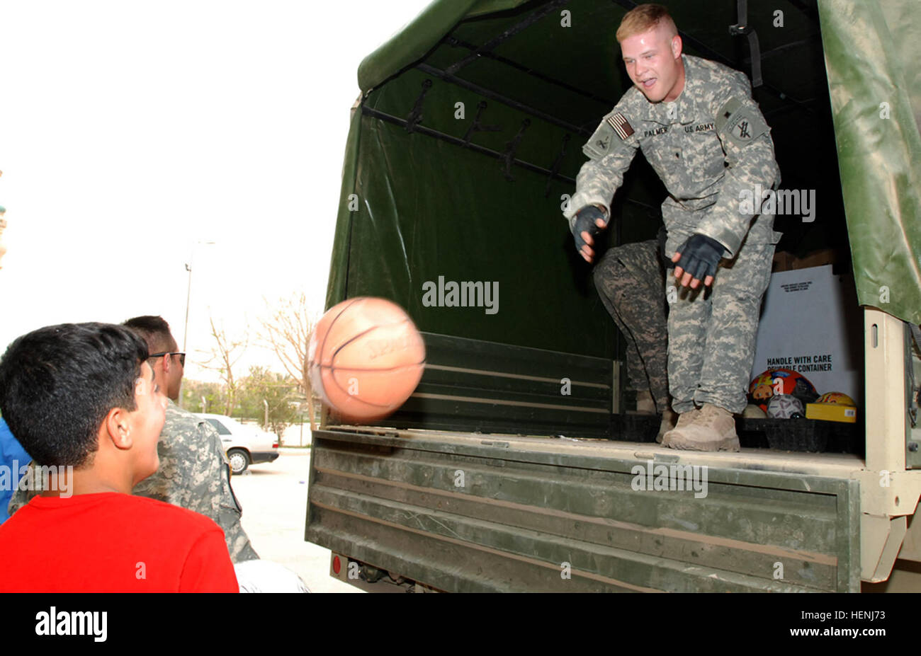 Spc. Ryan Palmer, a Bad Axe, Mich., native, tosses a basketball to an ...