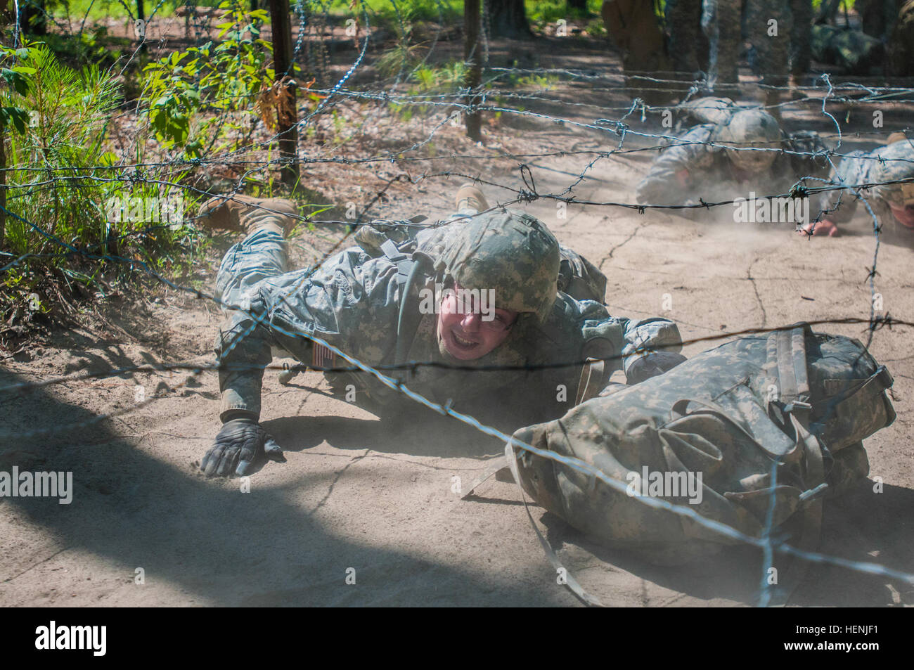 Soldiers crawl under concertina wire with their combat lifesaver (CLS ...