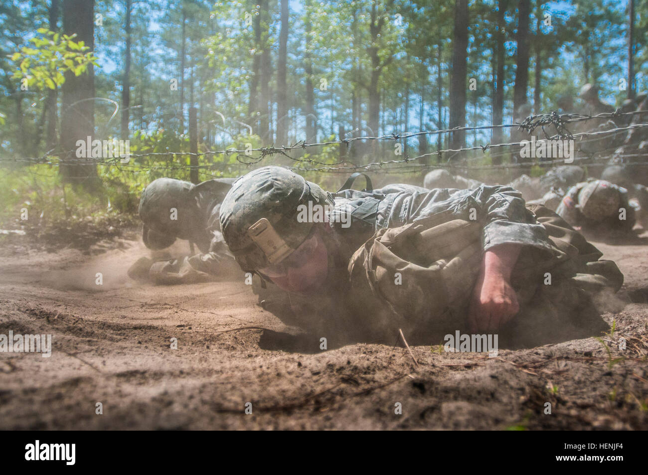 Soldiers crawl under concertina wire with their combat lifesaver (CLS ...
