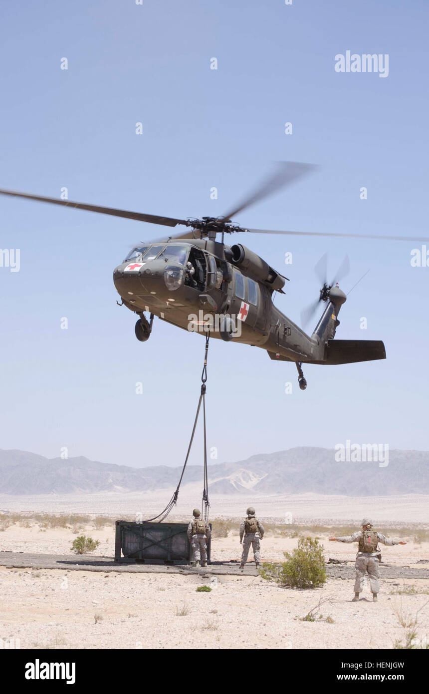 A New Mexico National Guard UH-60 Blackhawk helicopter lifts a large ...
