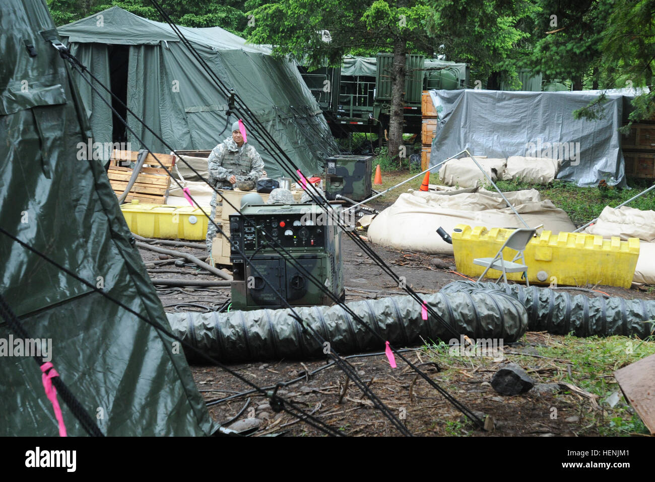 Army Sgt. Loy Atalig, a shower/laundry and clothing repair specialist ...