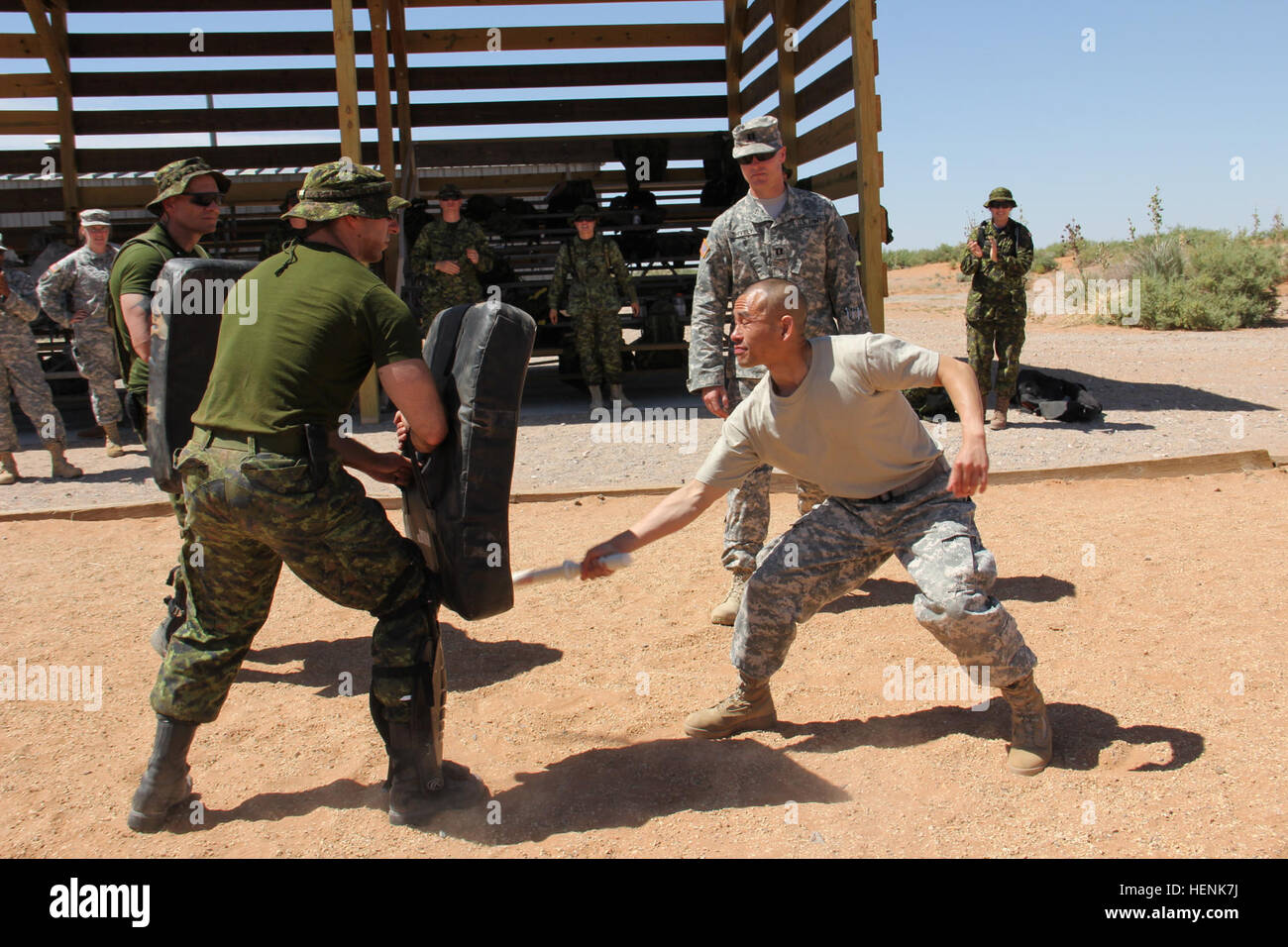 A Soldier (right) attempts to complete an obstacle course after being ...