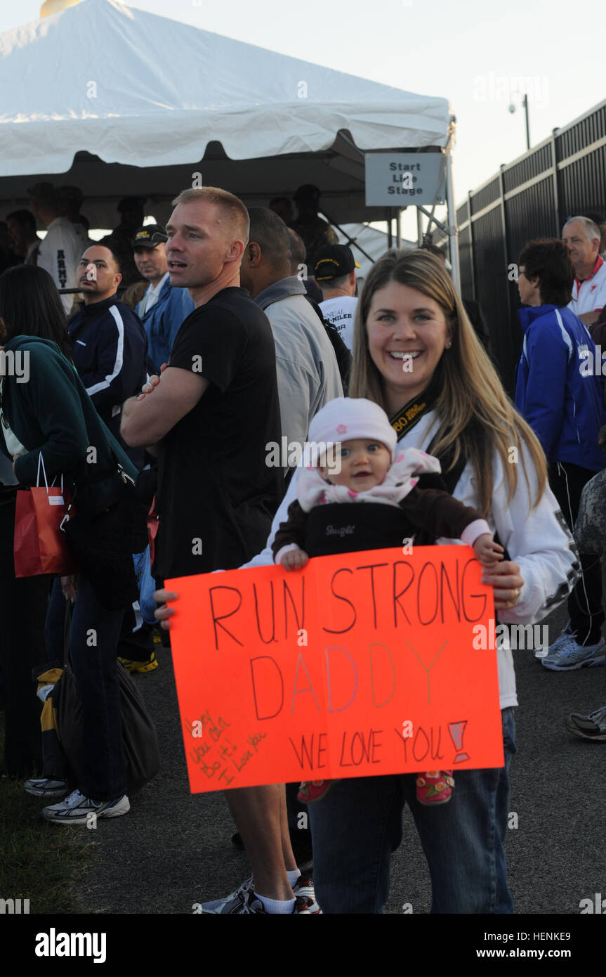A U.S. Army family member cheers during a military event, highlighting ...