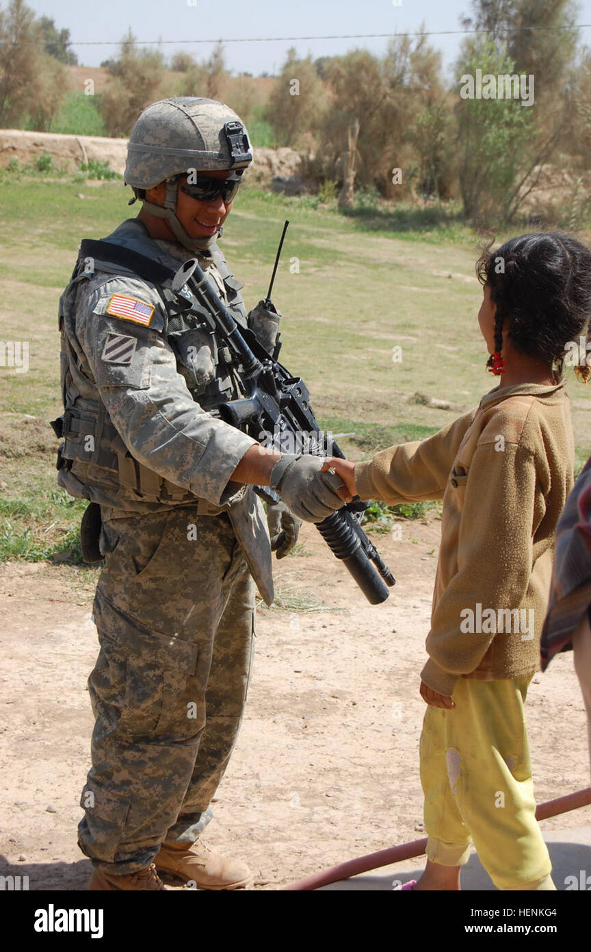 Sgt. Michael Rios, a native of Sebastian, Texas, greets a young girl ...