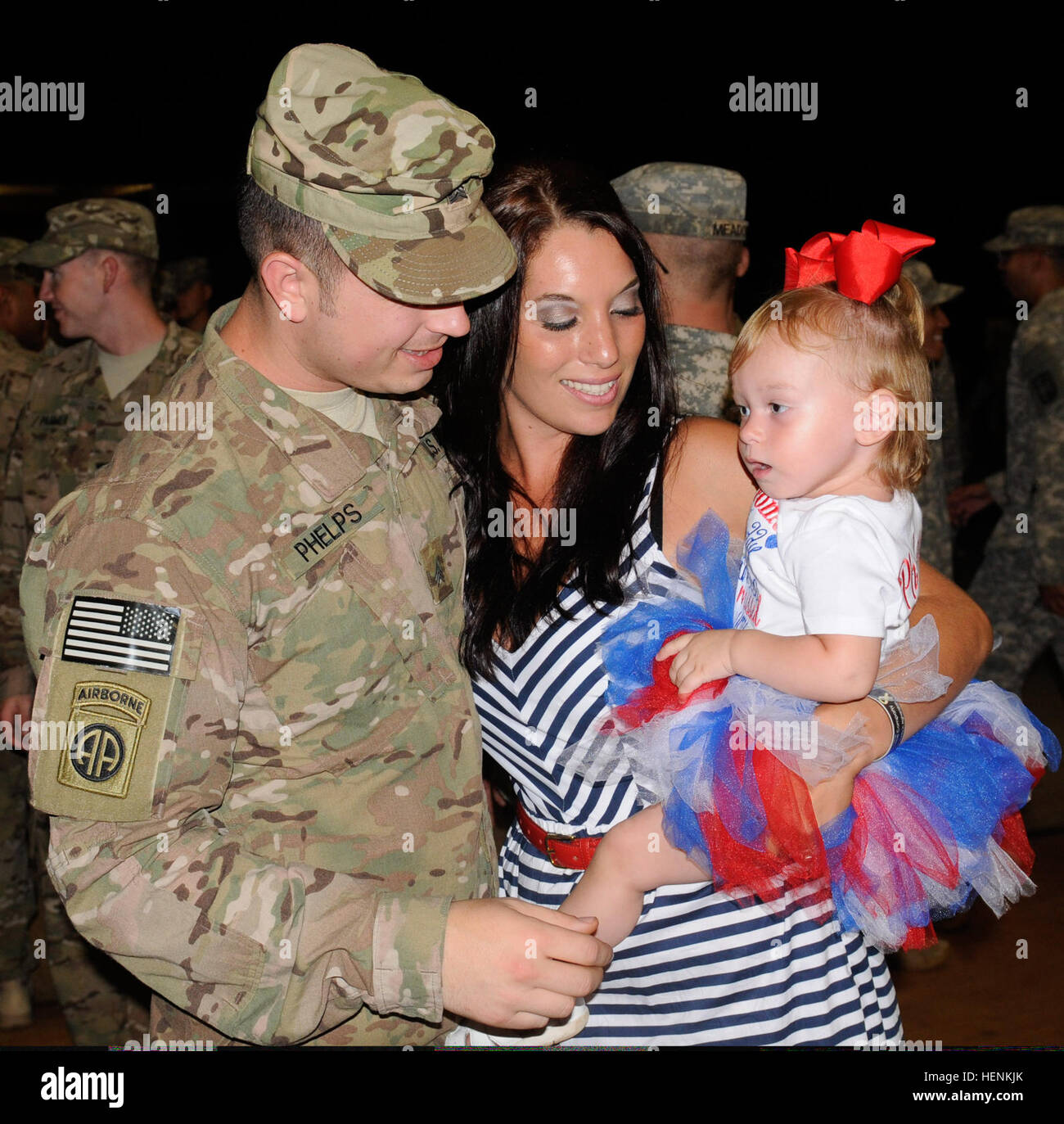 U.S. Army Sgt. Nathan Phelps, left, embraces his wife Kalan, and his ...