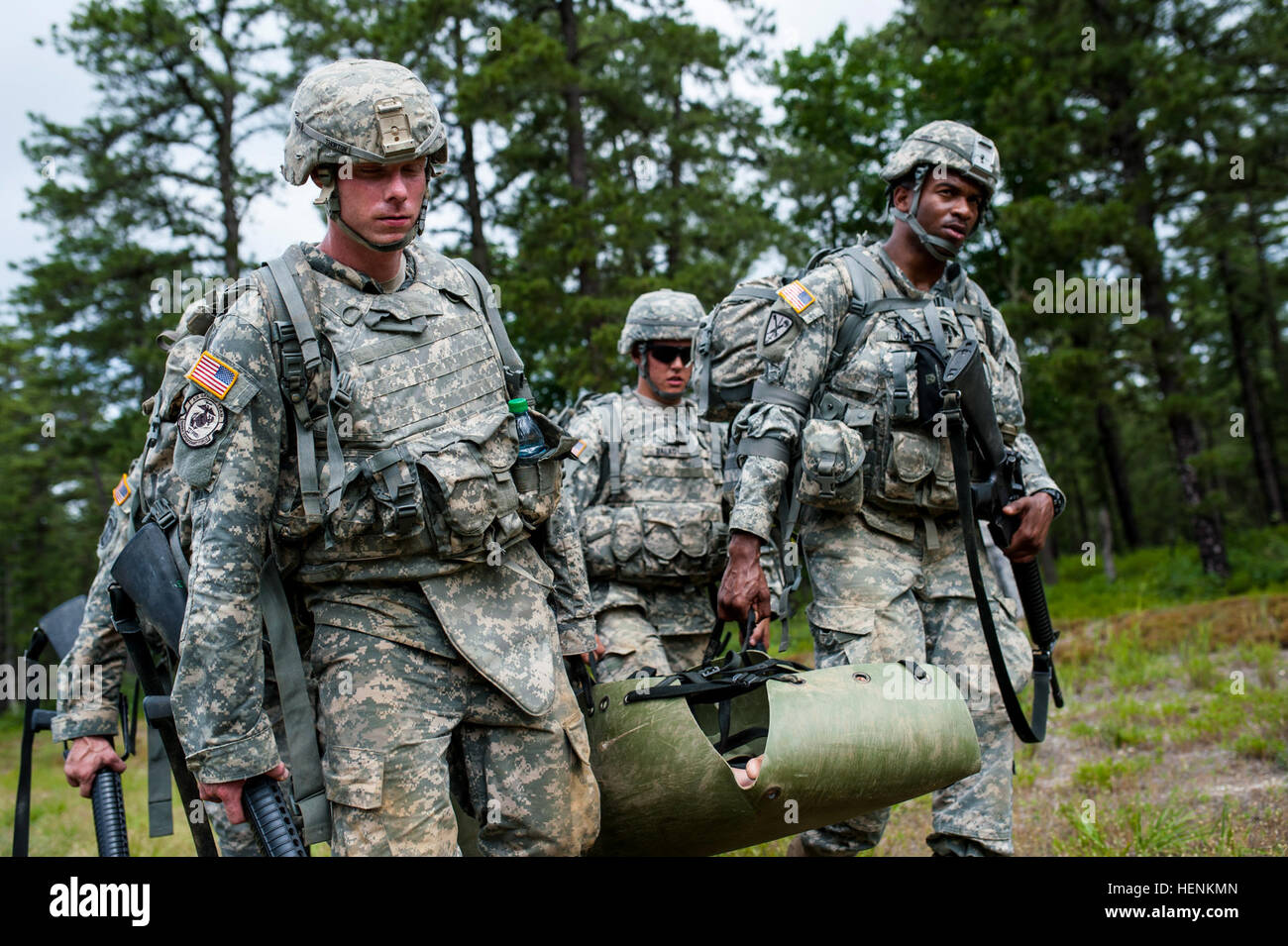 A team of four Soldiers carries a 165-pound dummy, which they have to ...