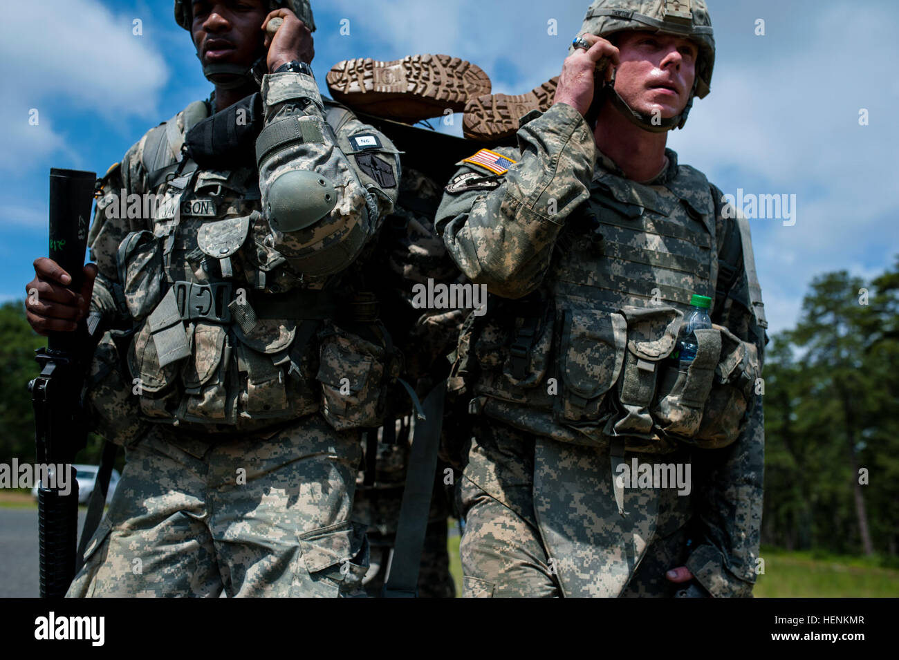 A team of four Soldiers carries a 165-pound dummy, which they have to ...