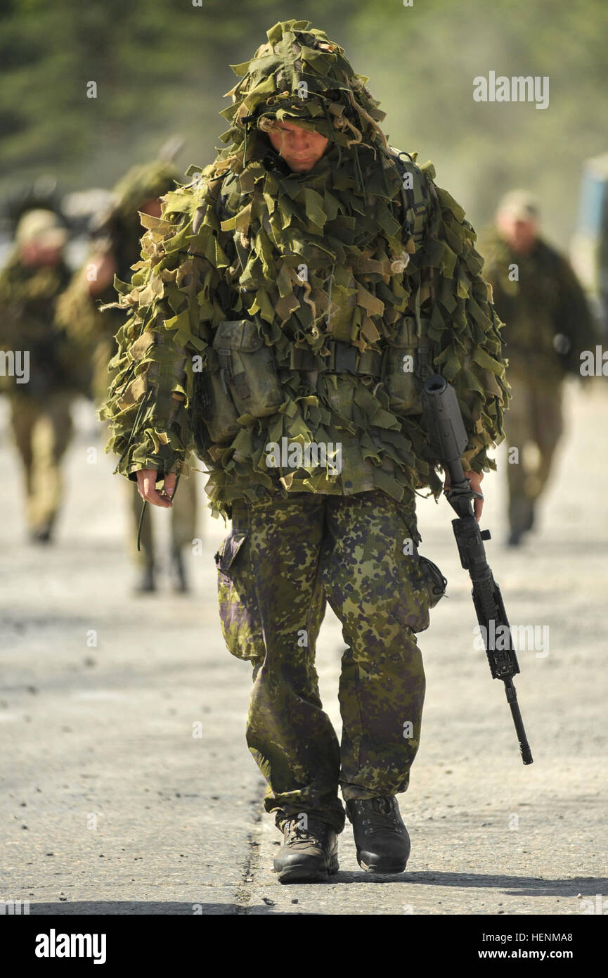 A soldier of the Royal Danish Army gets ready to conduct a live-fire ...