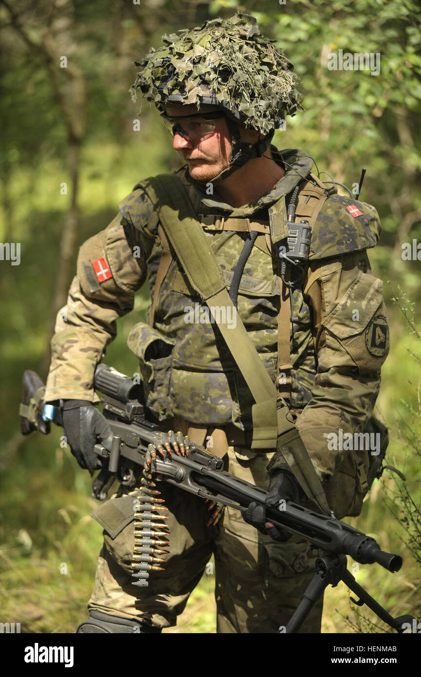 A soldier of the Royal Danish Army moves to an objective during a live ...