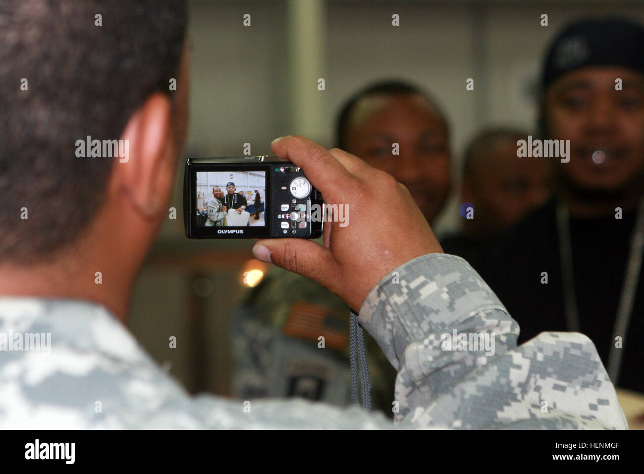A Soldier poses for a photo with Twista during the rapper’s visit to ...