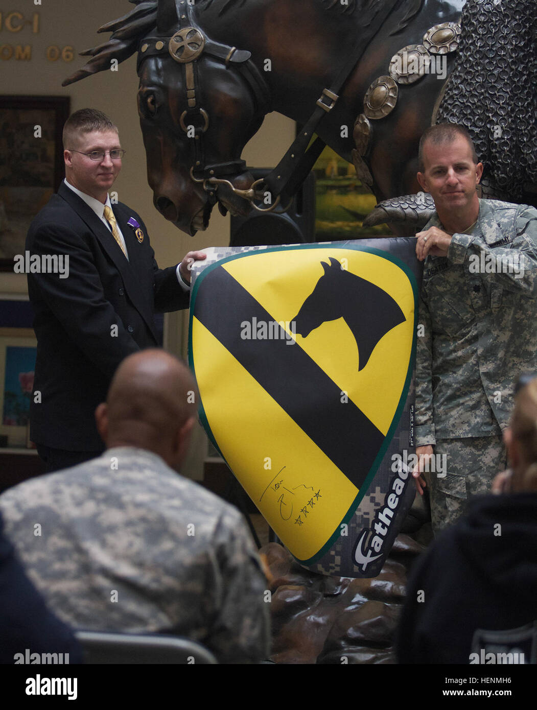 Retired Sgt. James Wilson presents a signed 1st Cavalry Division poster ...