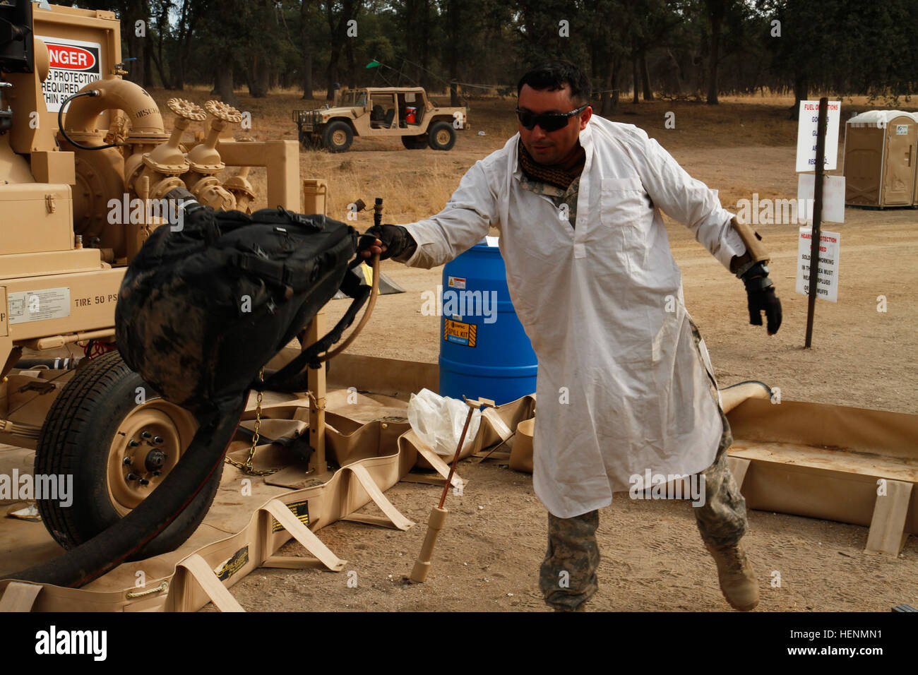 U.S. Army Sgt. Javier Martinez throws a prop explosive at a fuel ...