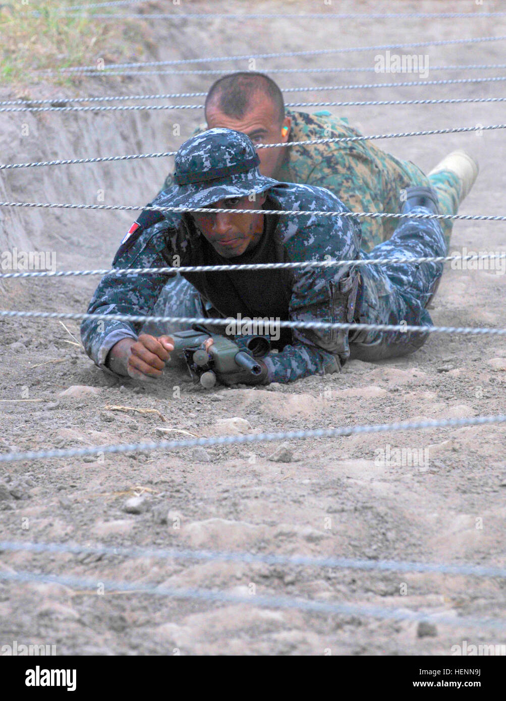 The Costa Rican special operations team low-crawls under wire as part ...