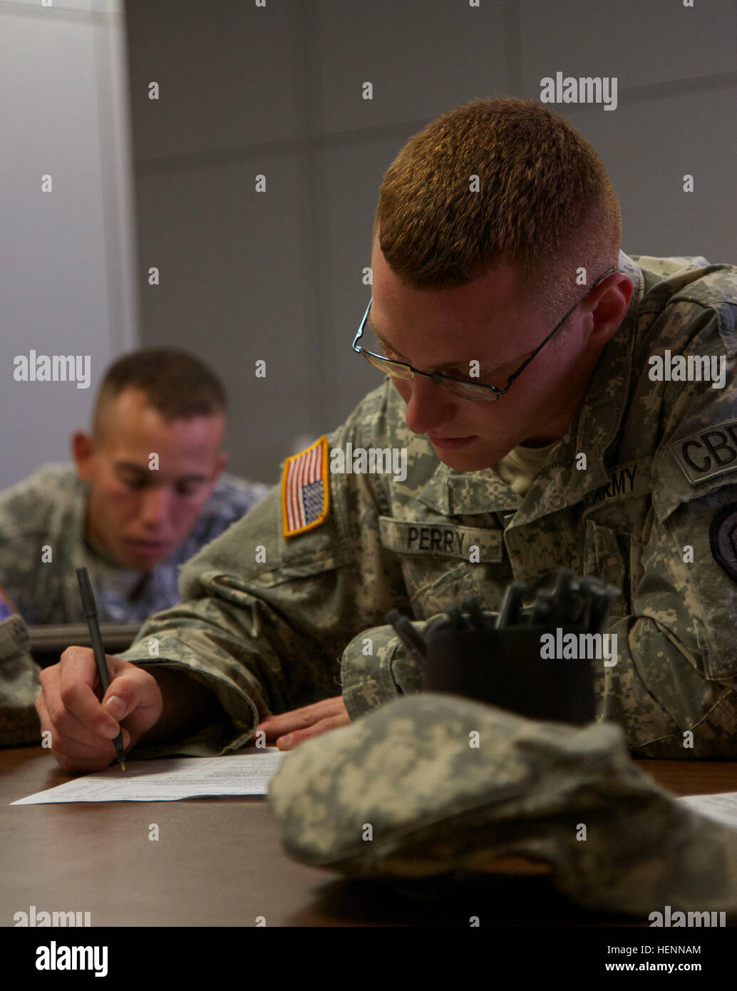 Spc. Thomas Perry fills out medical paperwork during in-processing for ...