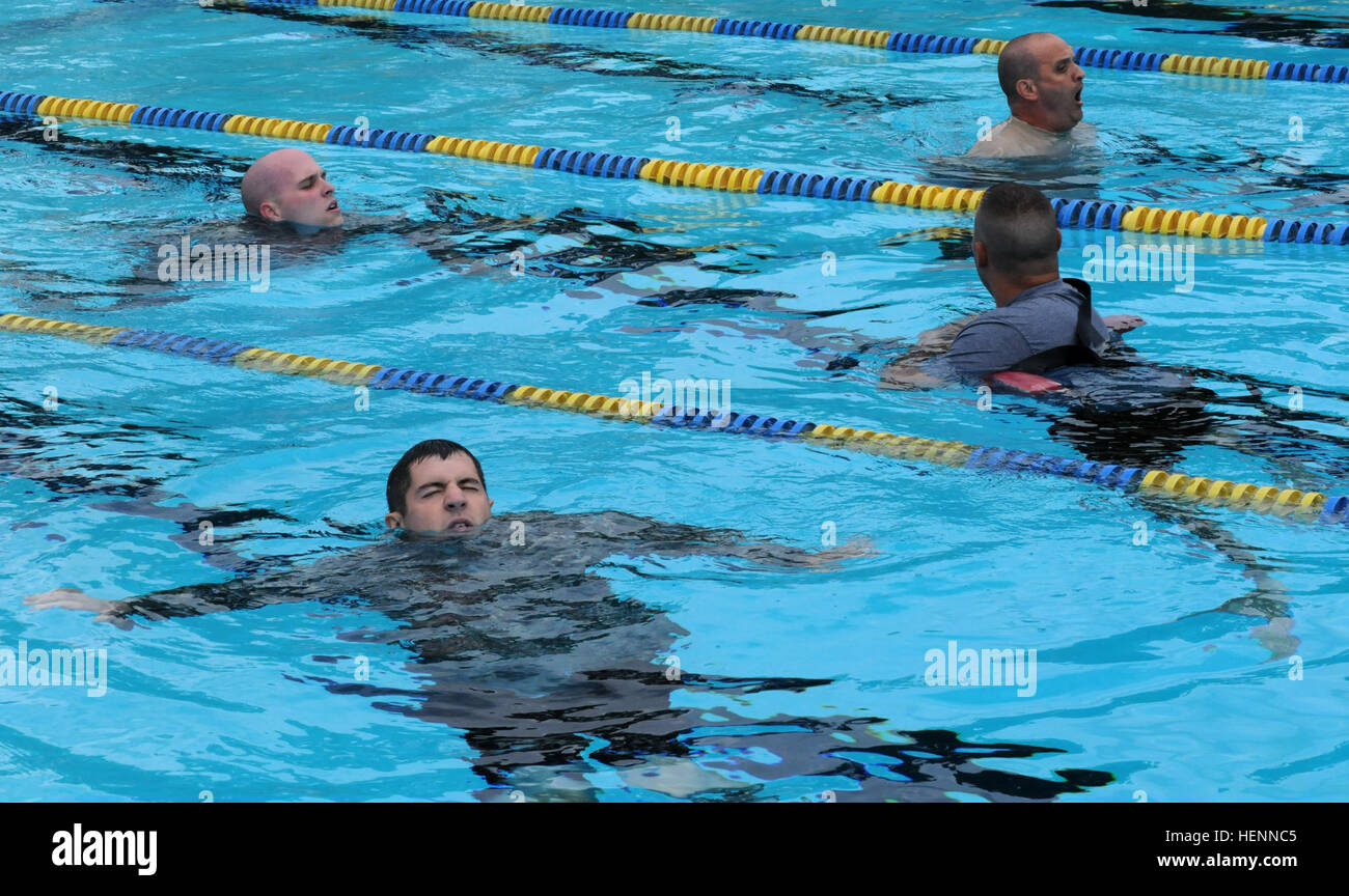 Charlie Company Soldiers participate in the 100-Meter swim in uniform ...