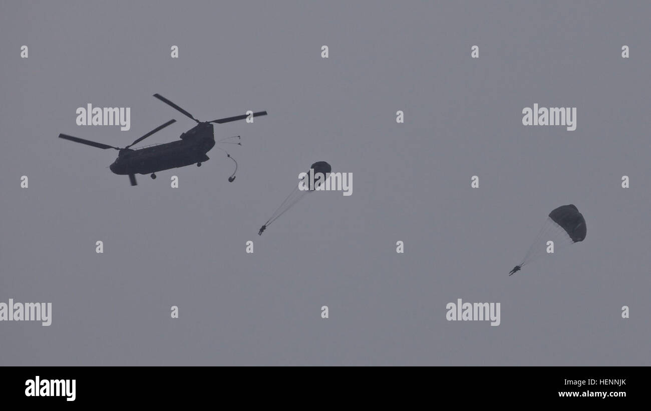 A group of U.S. Army paratroopers jumps from a CH-47 Chinook Helicopter ...