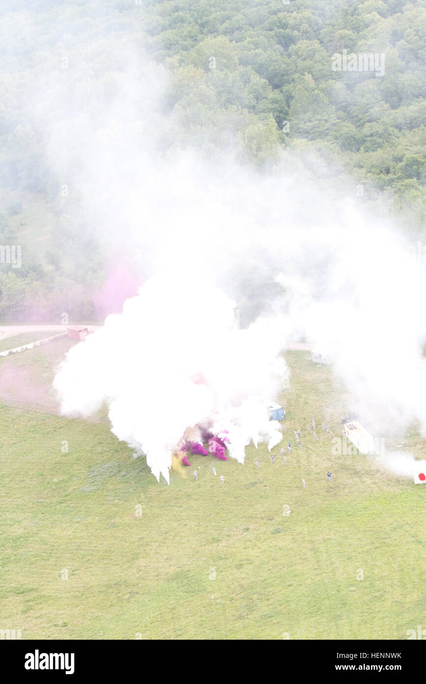 Soldiers use pyrotechnics in a simulated disaster area at Camp ...