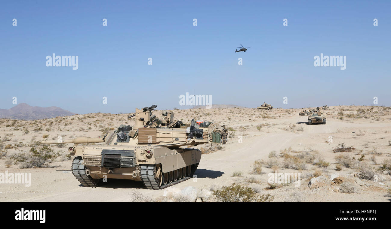 An M1 Abrams tank maneuvers through the National Training Center while ...