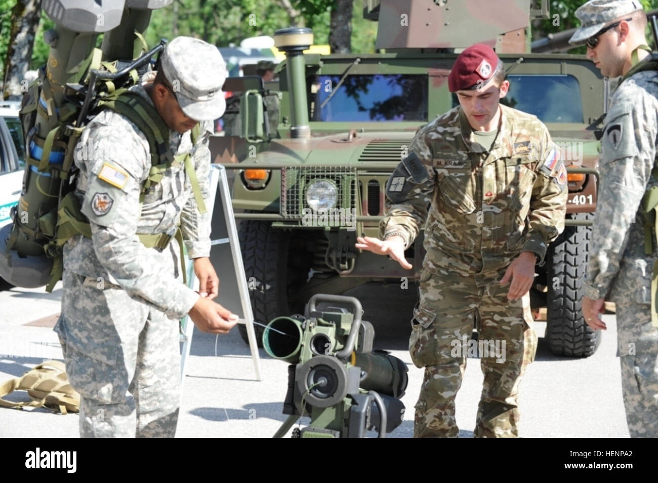 A Slovenian army soldier explains his weapons system during a military ...