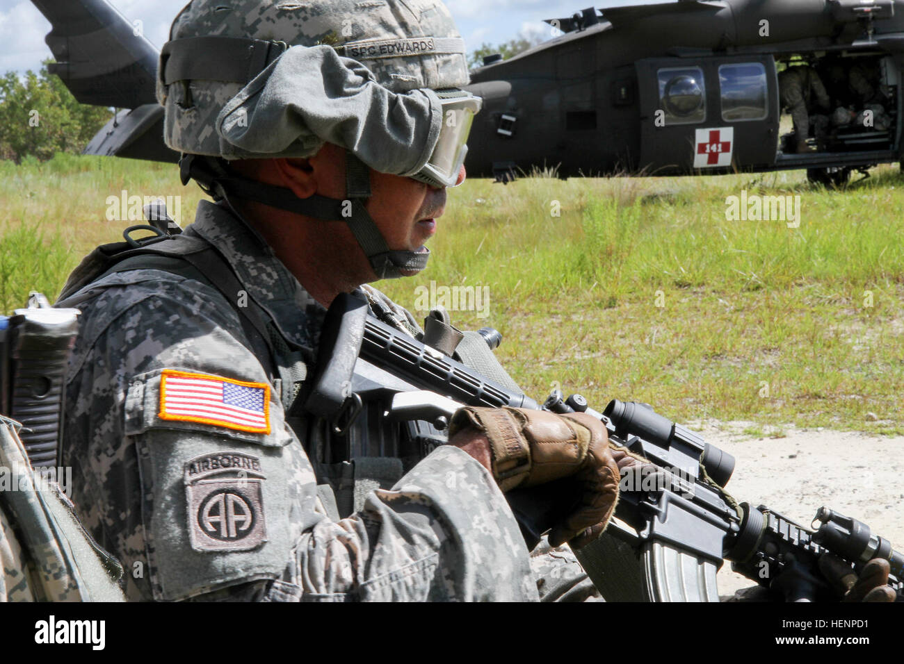 Army Reserve Spc. Michael Edwards provides security while Soldiers load ...