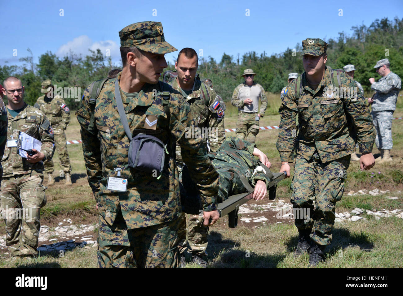 Members of a multinational search and rescue team evacuate a role ...