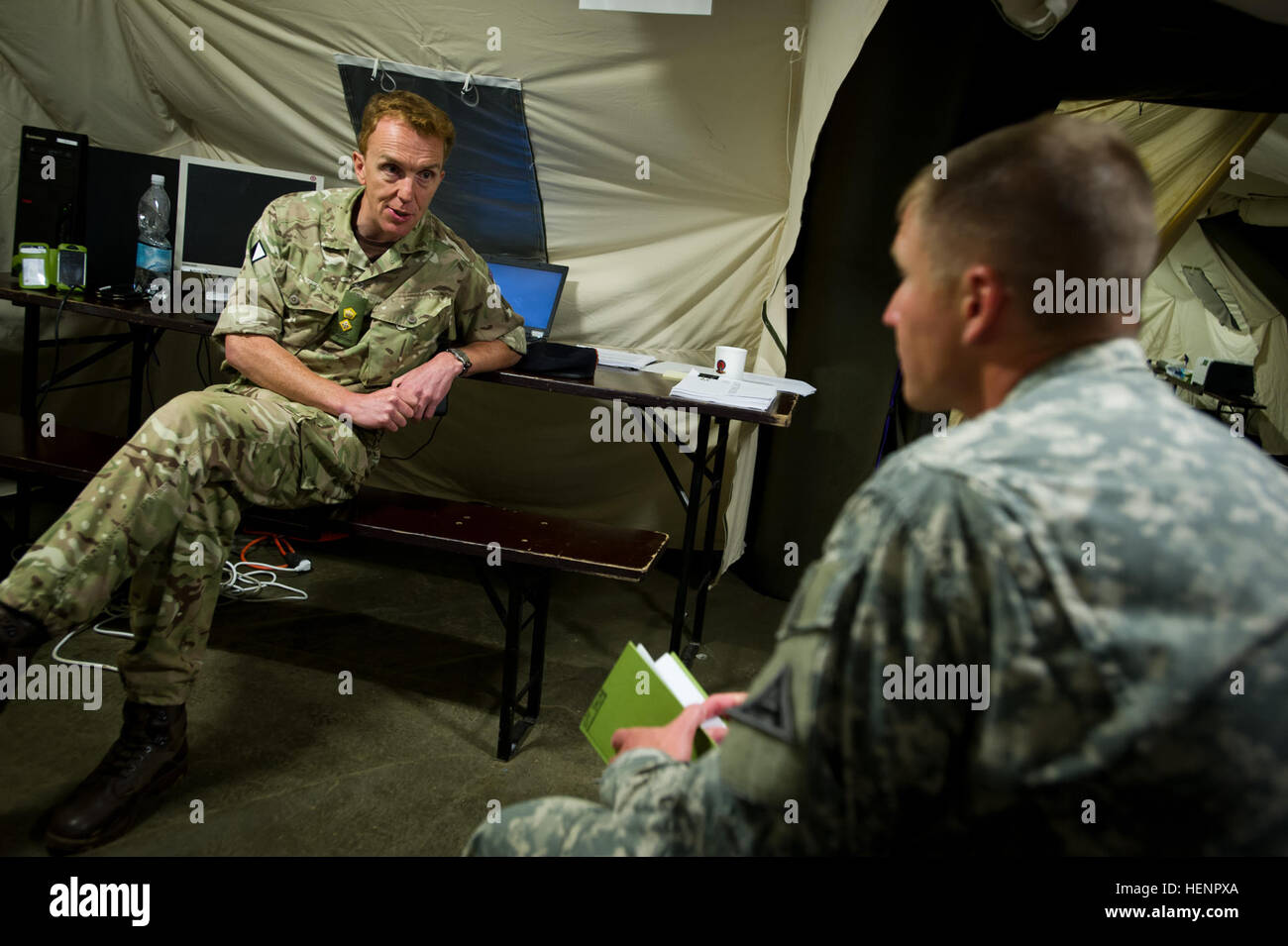 British and U.S. Army officers coordinate during a computer-simulated ...