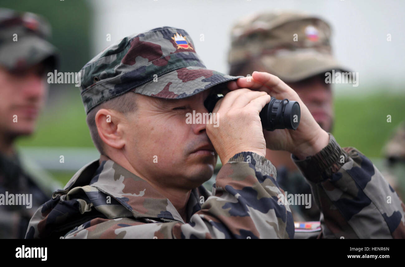 Slovenian Armed Forces Pvt. Ales Simenko looks through a night vision ...