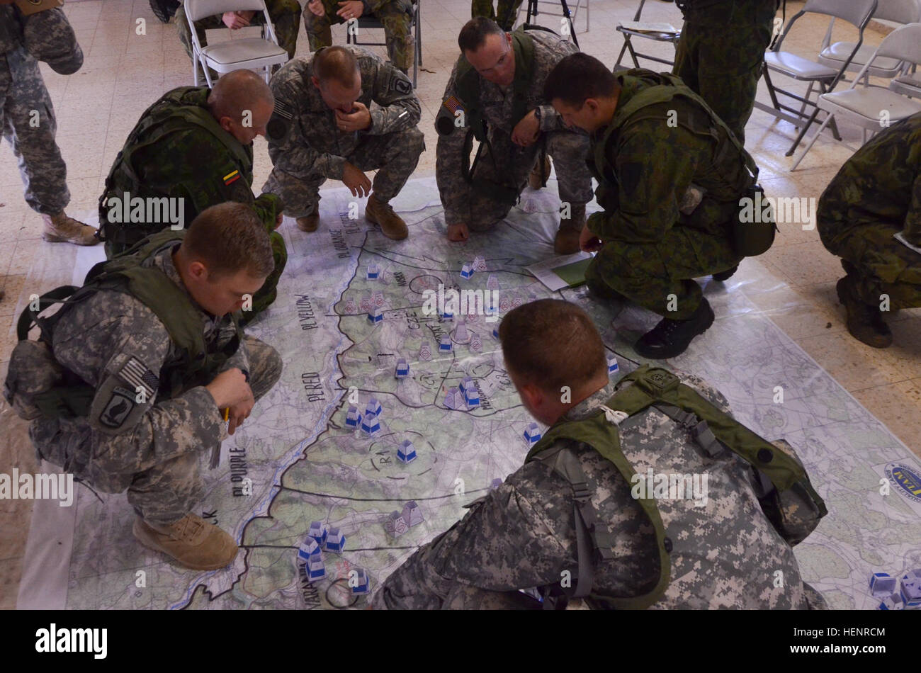 U.S. and Lithuanian soldiers review a combined arms rehearsal map ...
