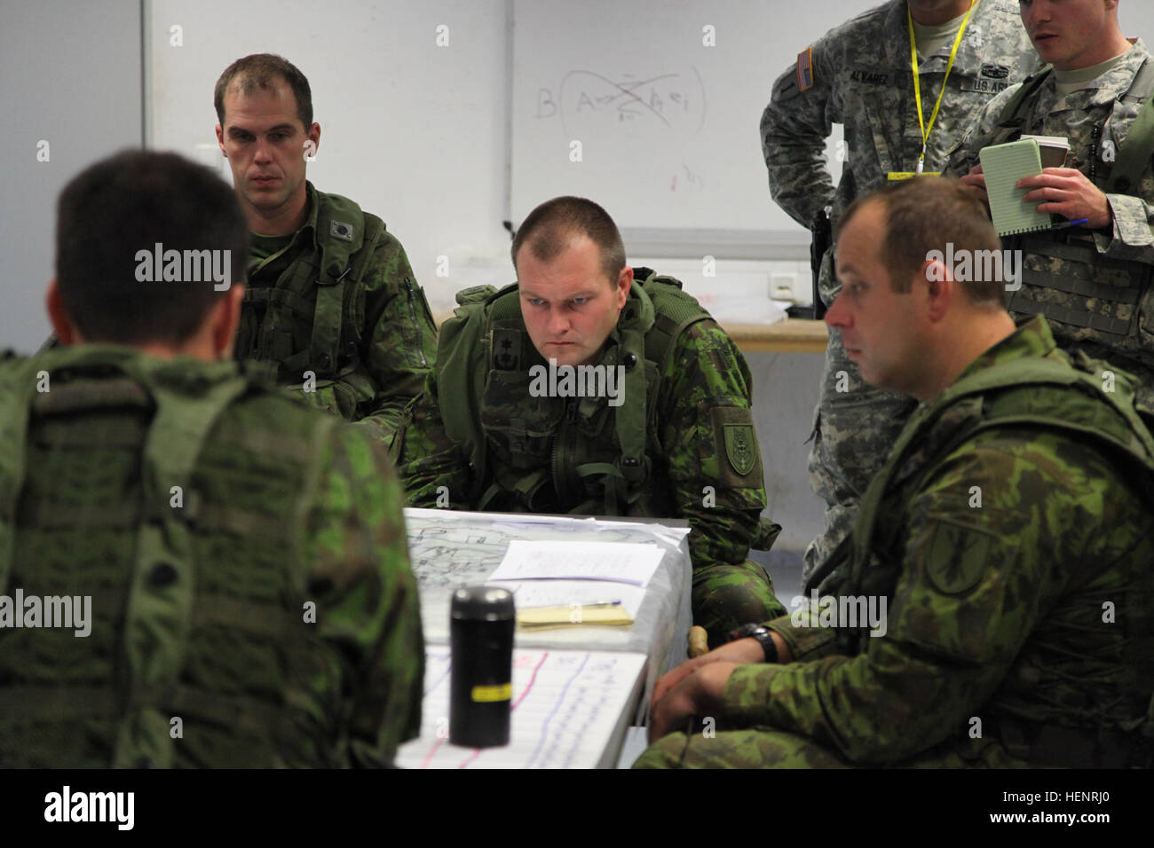 Lithuanian and U.S. Soldiers study maps at the Joint Multinational ...