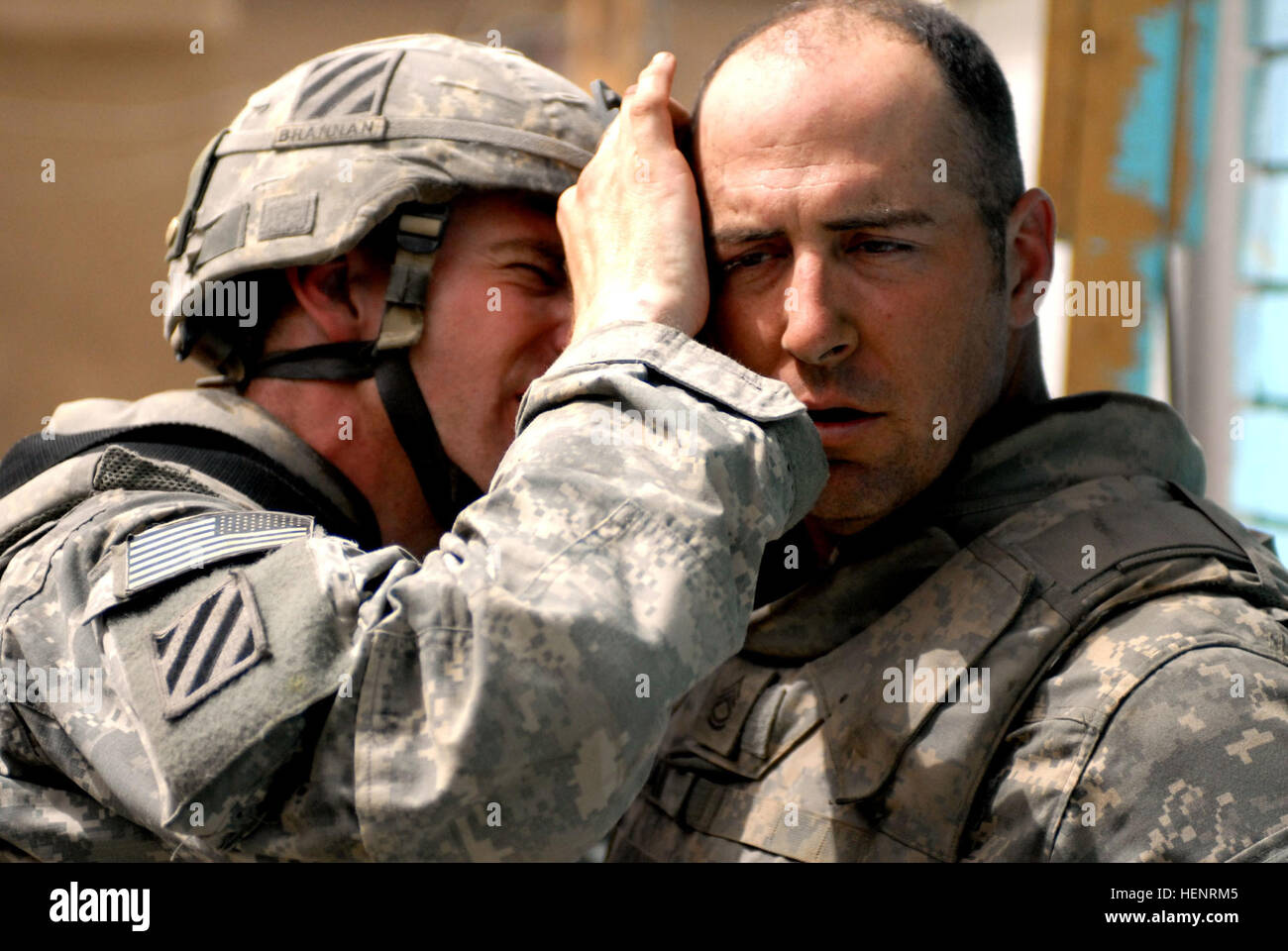 Sgt. Paul Brennan, a Wellingborough, England, native, checks the ears ...