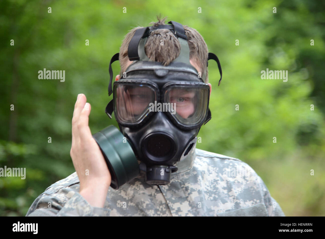 U.S. Soldier, assigned to the 52nd Signal Battalion, checks his gas ...
