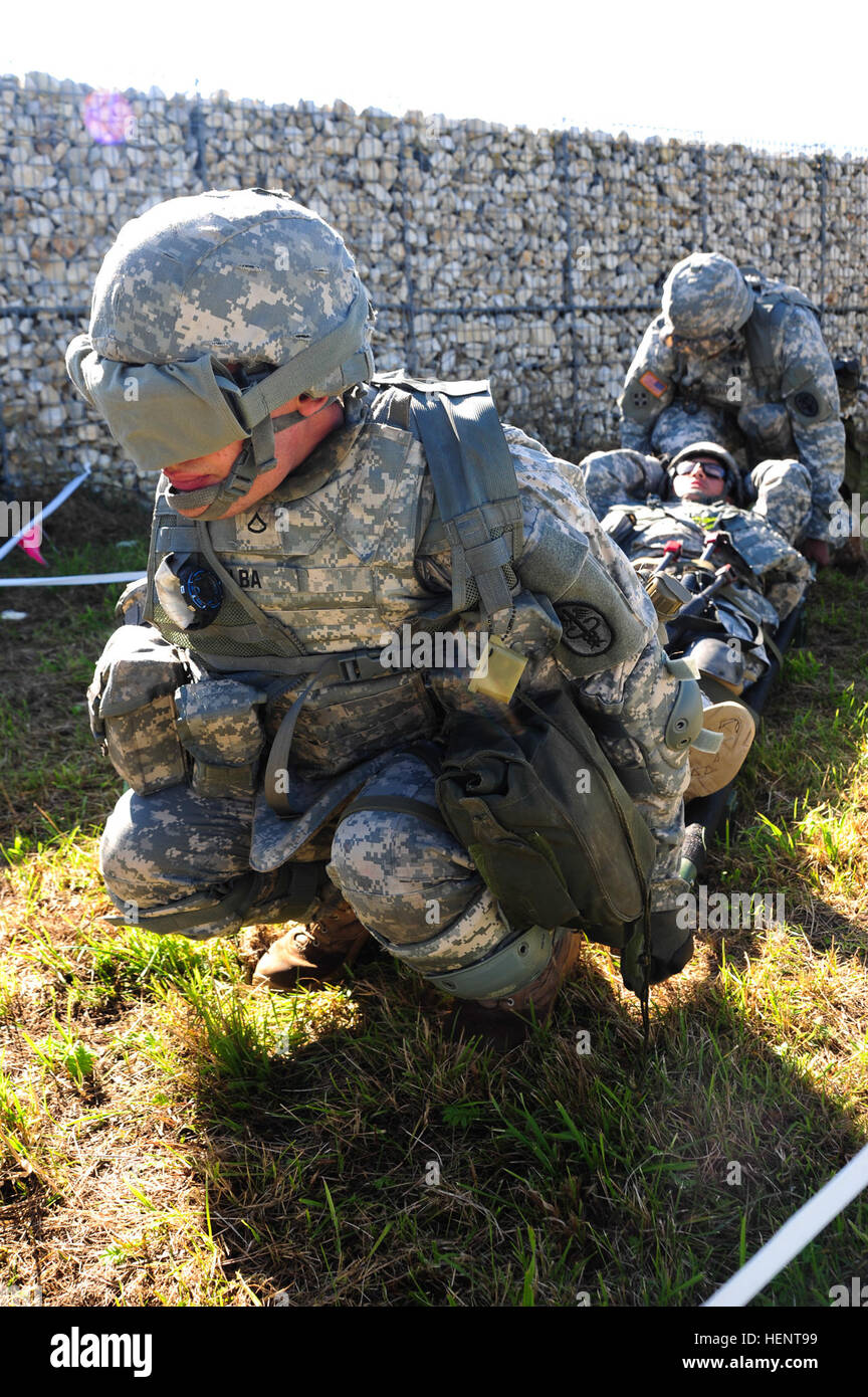 U.S. Army Staff Sgt. Miguel Garza (center), guides his two blindfolded ...