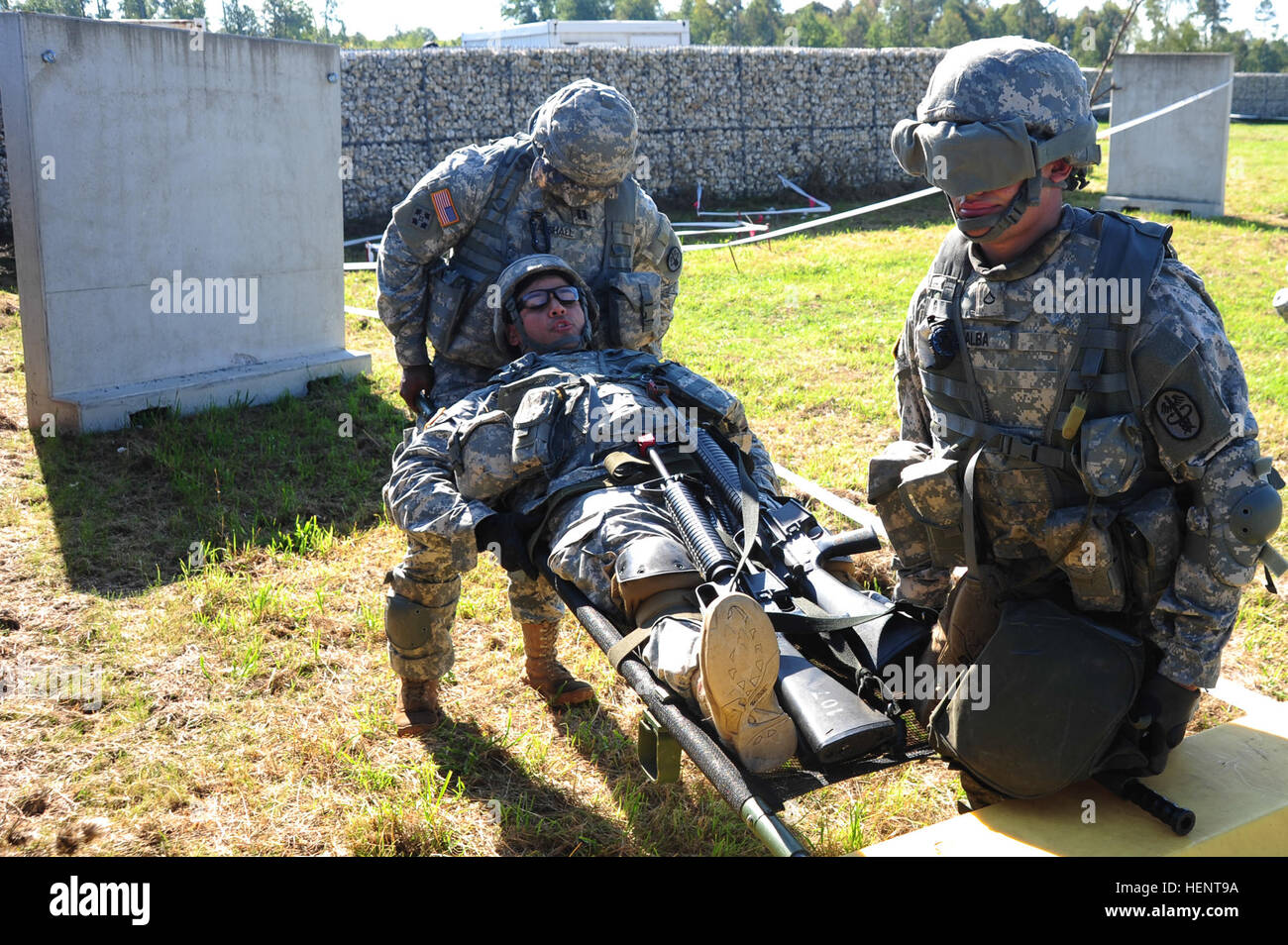 U.S. Army Staff Sgt. Miguel Garza (center), guides his two blindfolded ...