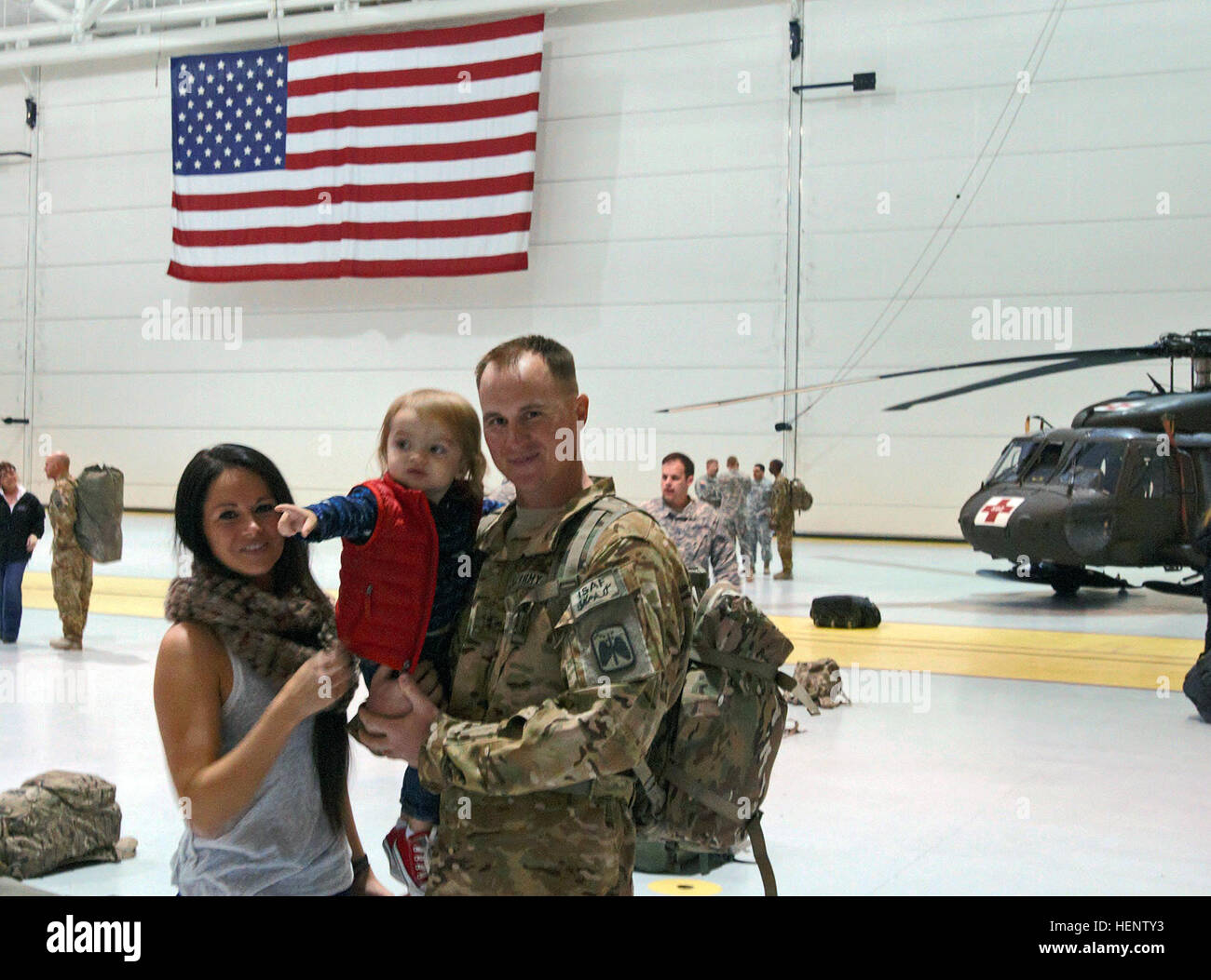 CW2 Daniel Herrington embraces his wife, Brittany, and their 16-month ...