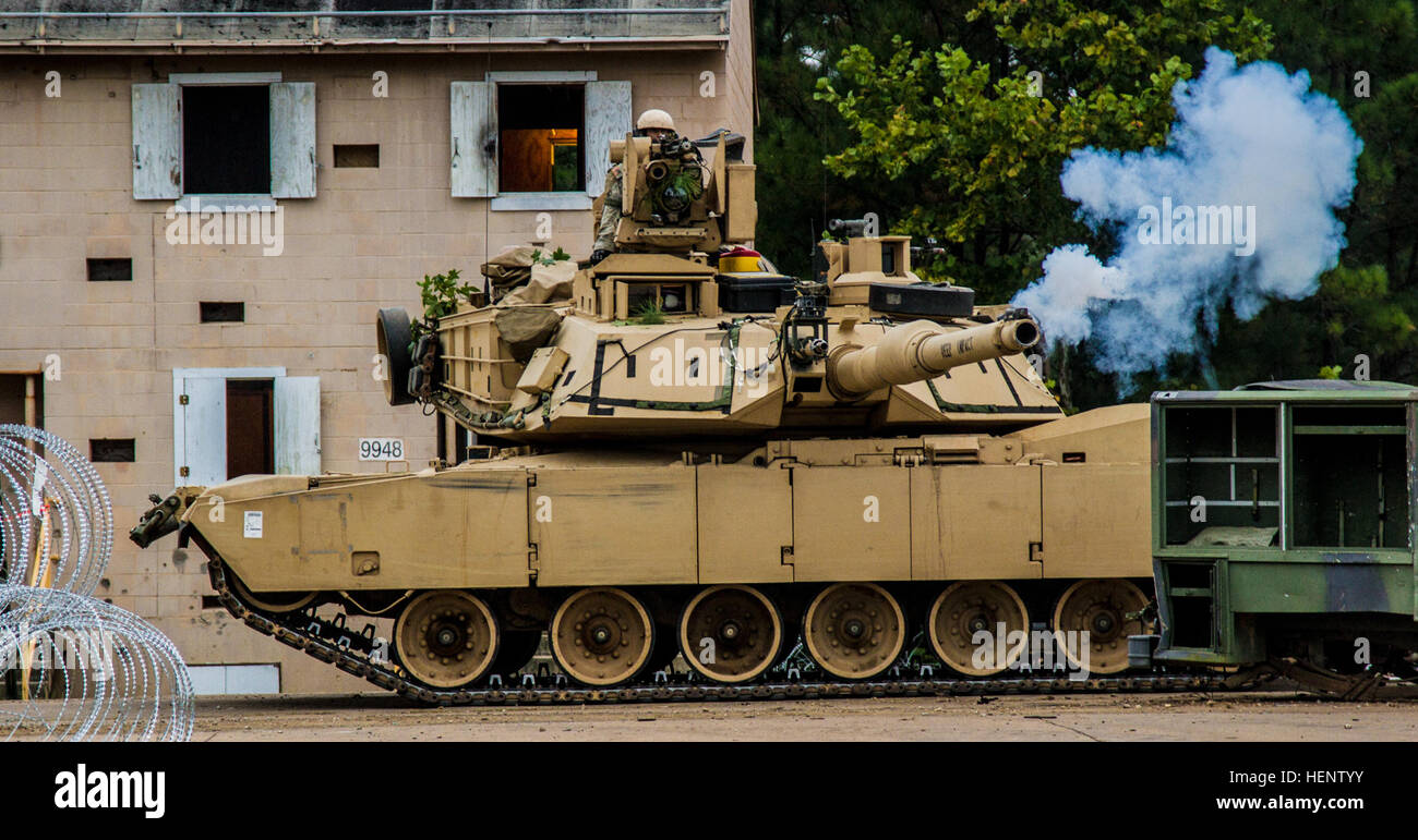 An M1A2 main battle tank fires a simulated tank round in the training ...