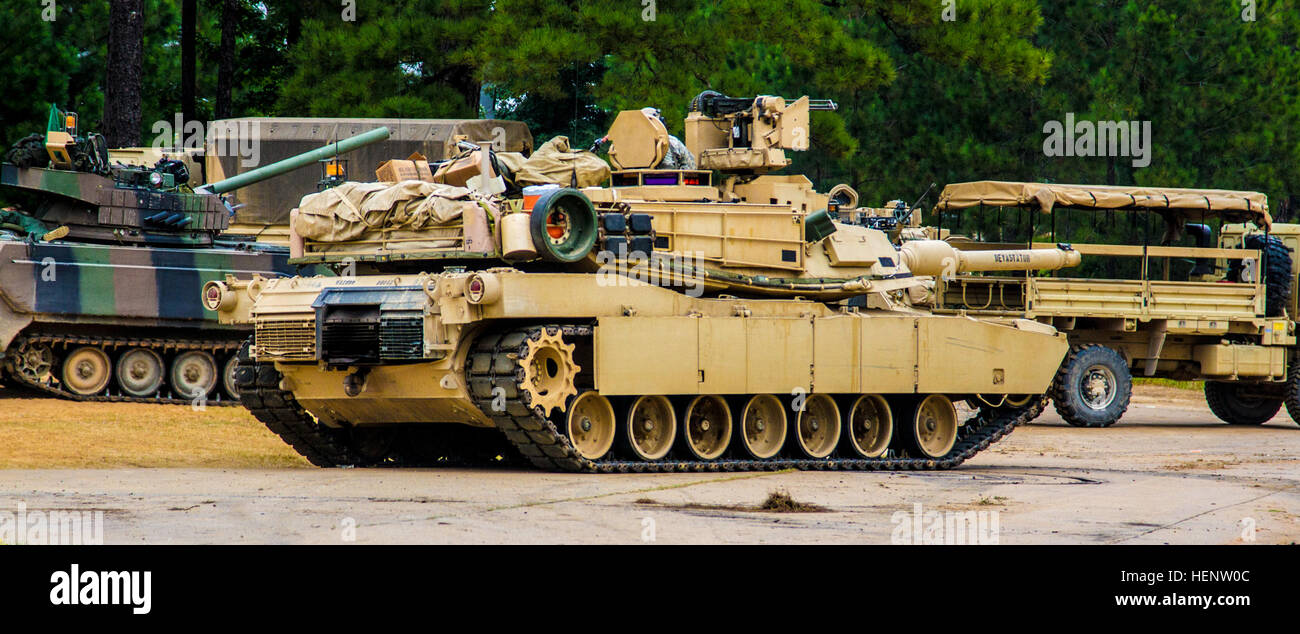 An M1A2 main battle tank pulls security next to destroyed enemy vehicle ...