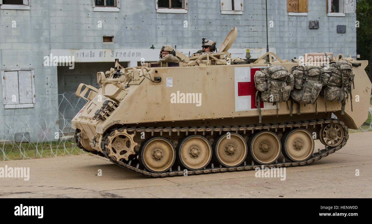 A medical M113, from 1st Battalion, 64th Armor Regiment, moves into the ...