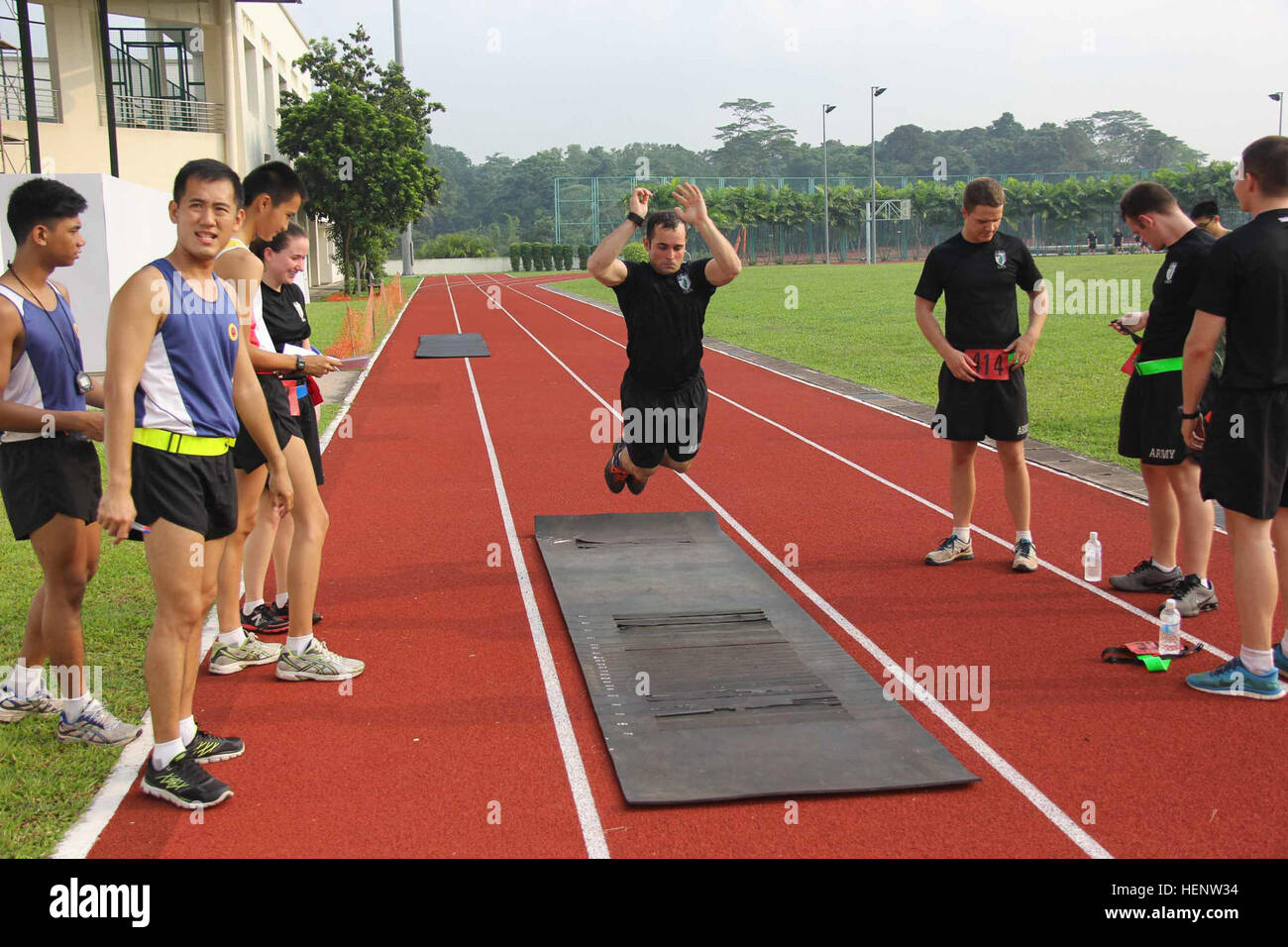 A Tropic Lightning Soldier performs a standing board jump for the ...