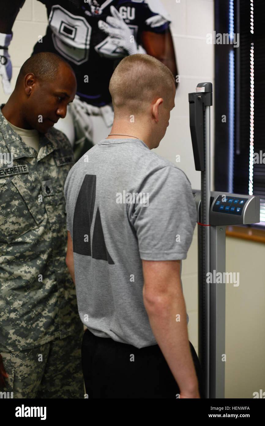 U.S. Army Staff Sgt. Kevin Hopson starts the height, weight and tape ...
