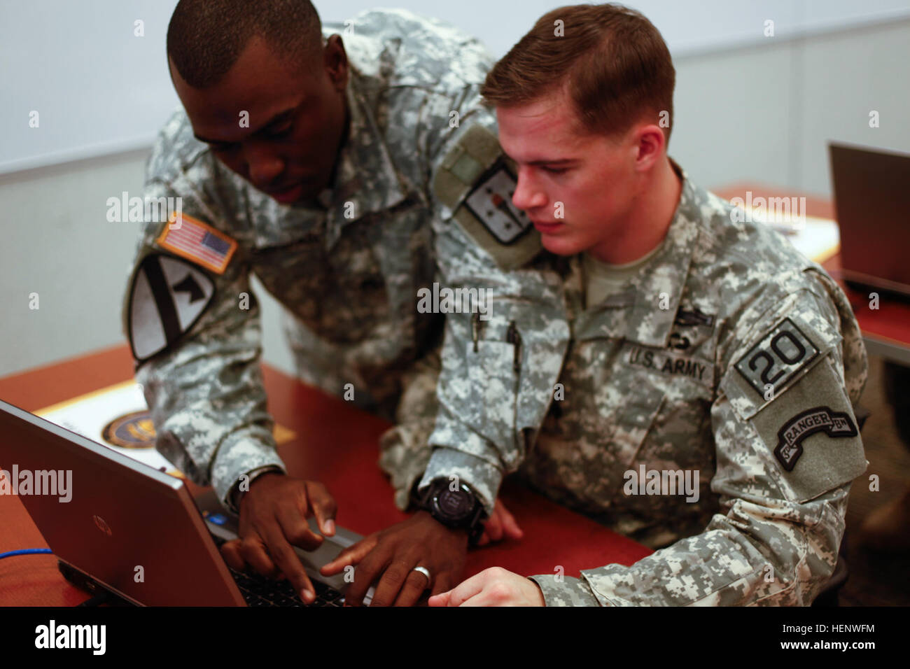U.S. Army Spc. Kevin Shinnick (right) gets his computer configured ...
