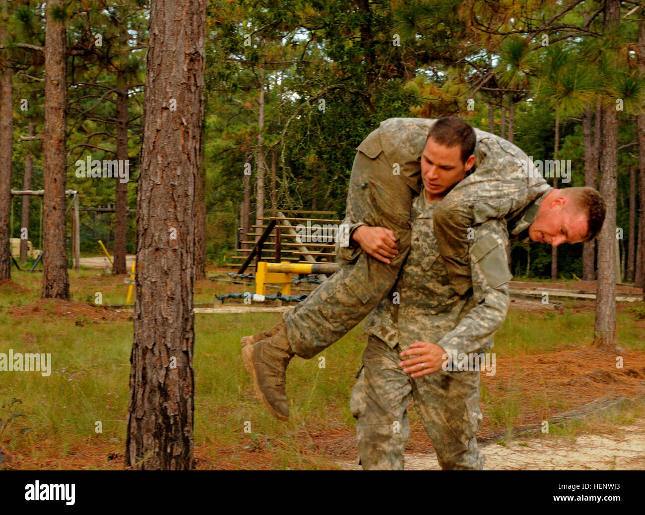 A medic assigned to the 82nd Airborne Division buddy carries another ...