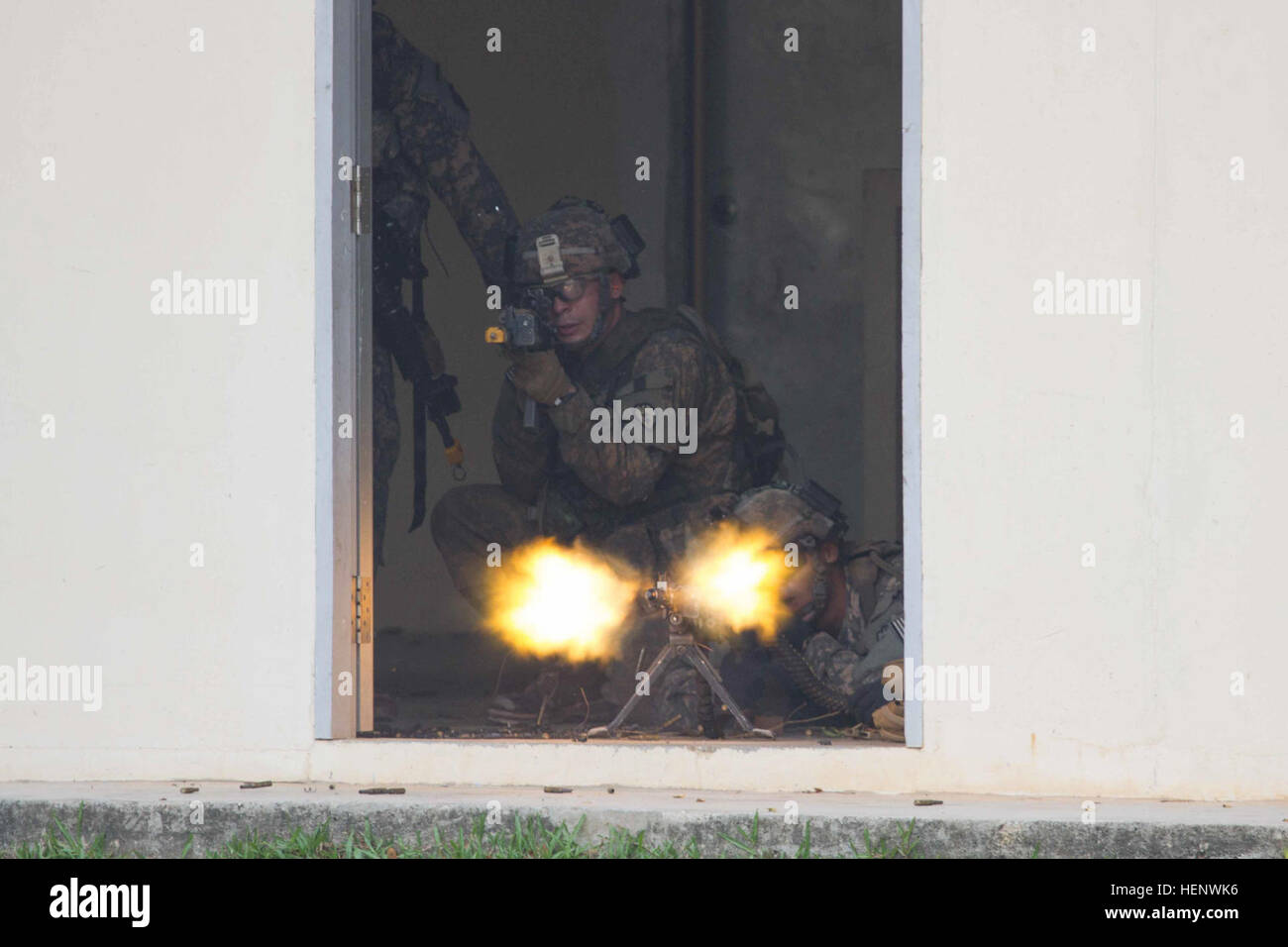 A Tropic Lightning Soldier returns fire to a simulated enemy force ...