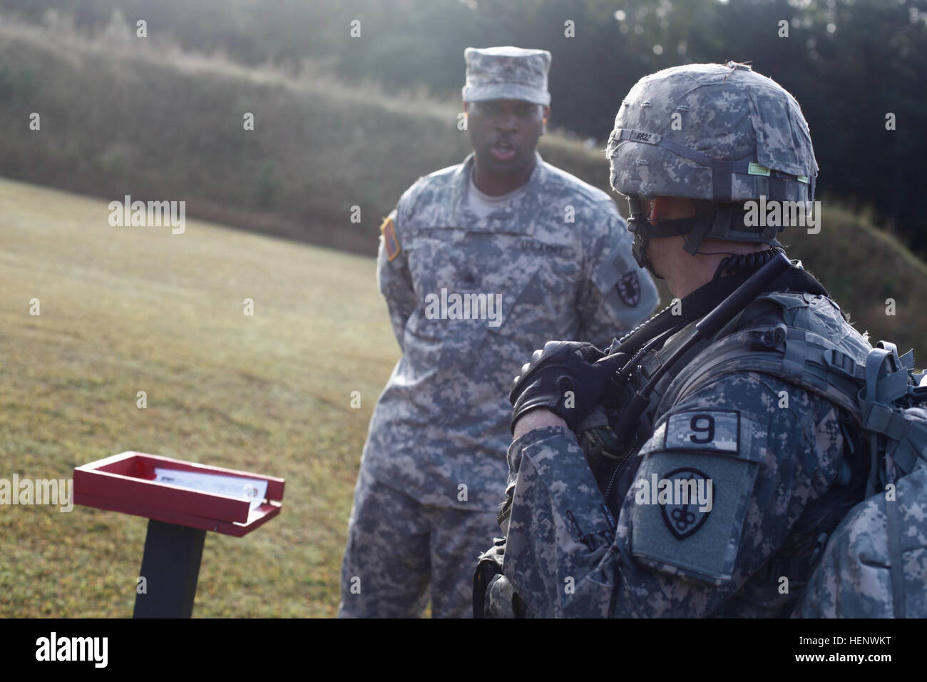 U.S. Army Staff Sgt. Luke Klein receives instruction before shooting at ...