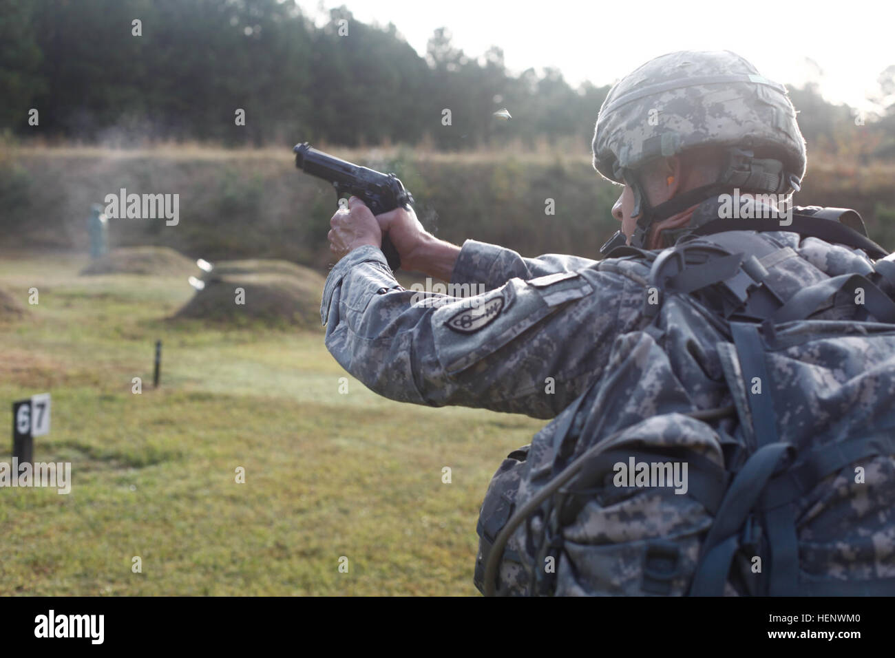 U.S. Army Staff Sgt. Landon Nordby shoots a M9 pistol at targets during ...