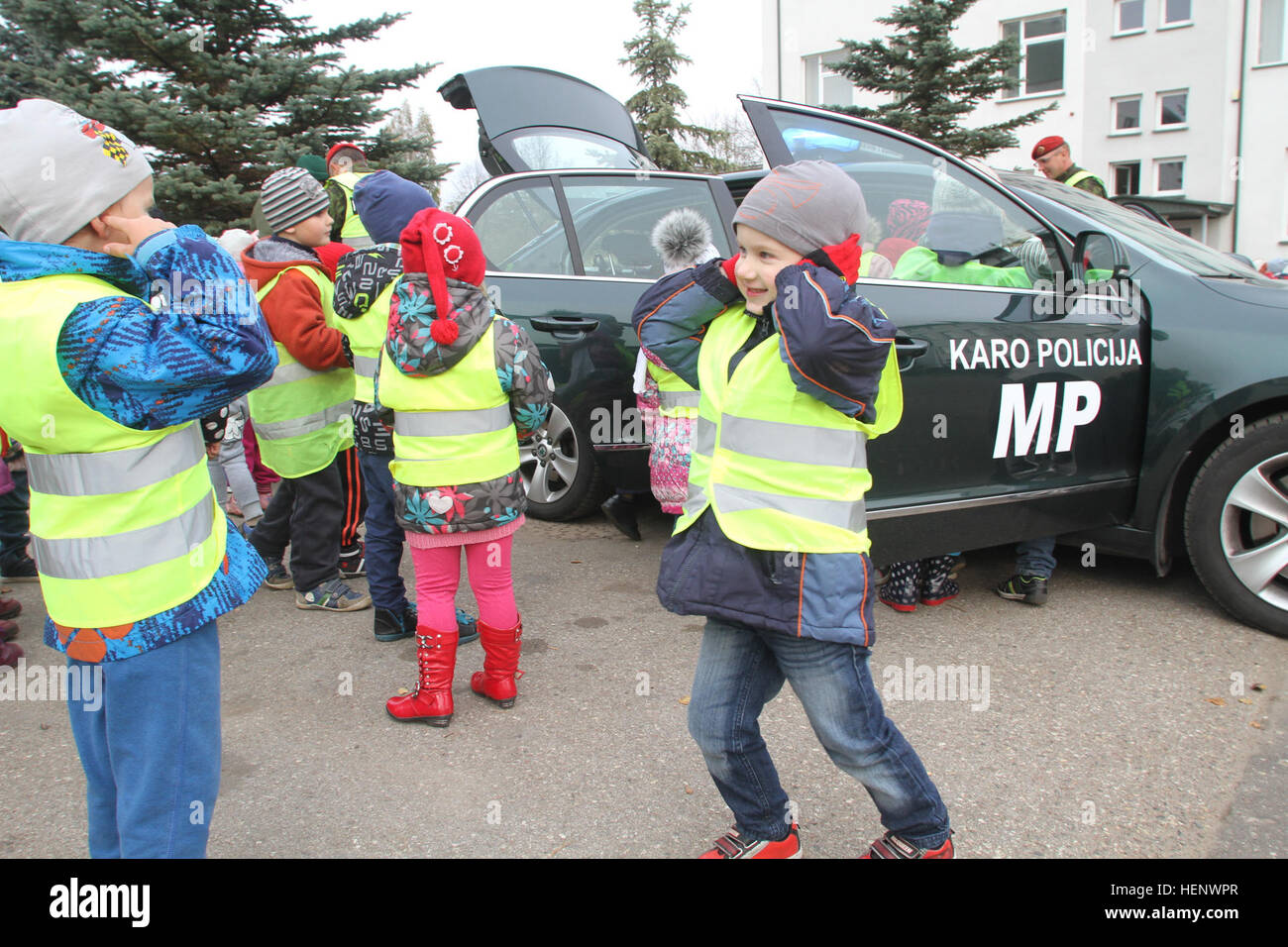 A Lithuanian school child covers her ears and runs from the sound of ...