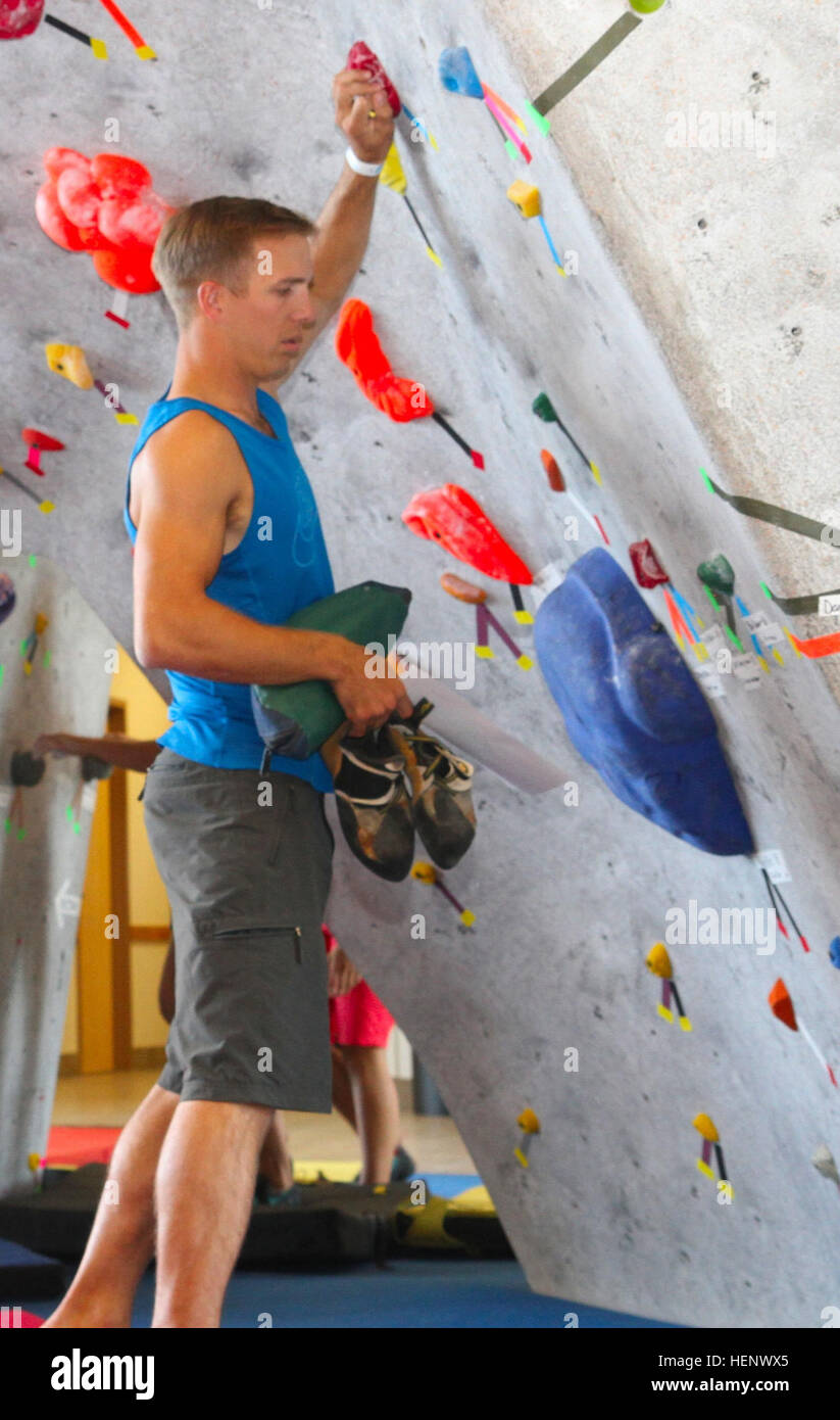 Army Sgt. Jasen Carlson plans his route on the climbing wall at the ...