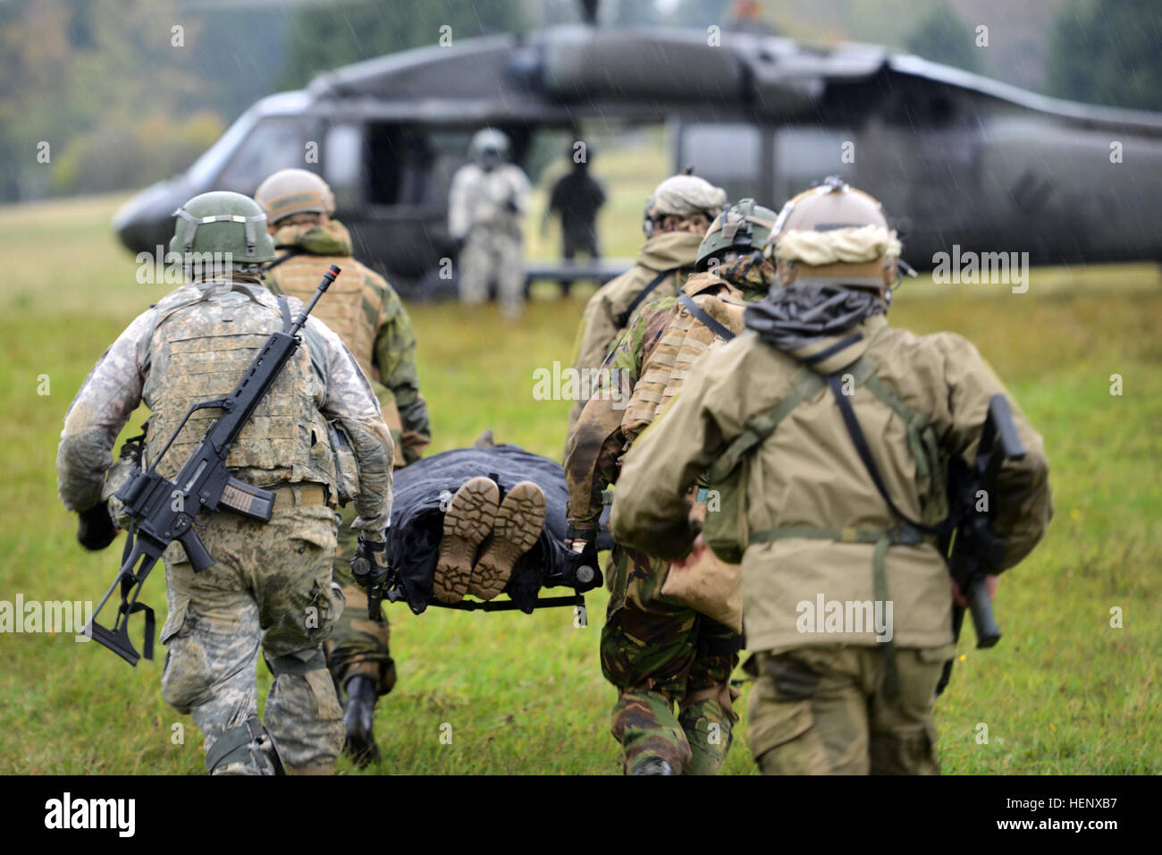 A team of international soldiers carry a stretcher with a simulated ...