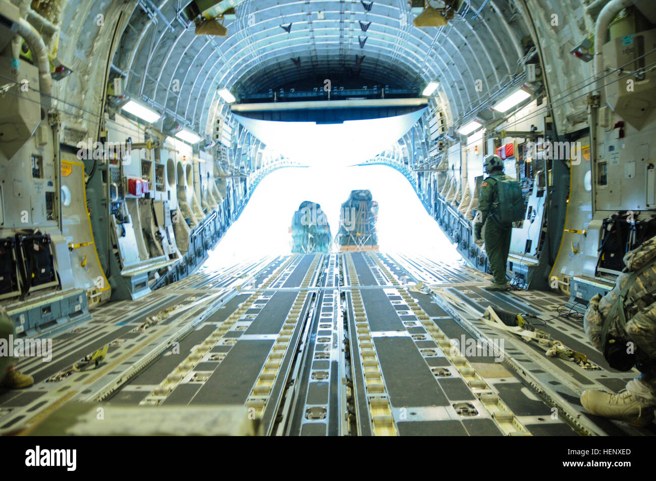 Two heavy-drop equipment rigs exit the tail of a C-17 Globemaster III ...