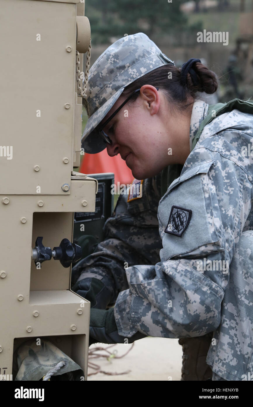 U.S. Army Spc. Pamela McClintock of Bravo Company, 44th Expeditionary Signal Battalion secures ...